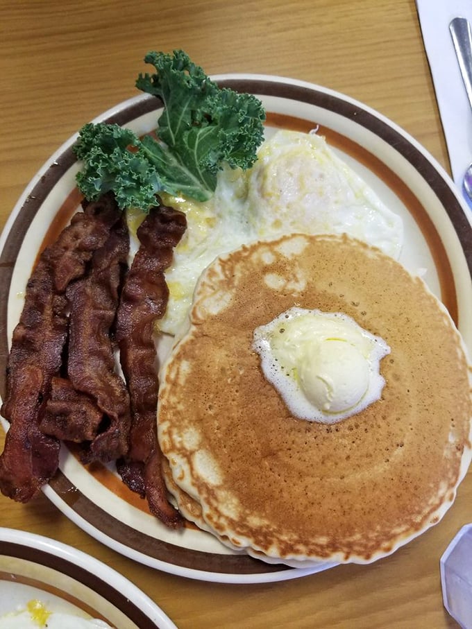 The breakfast trinity: perfectly cooked bacon, sunny eggs, and a pancake with butter melting into every pore. Add maple syrup and ascend to morning nirvana.