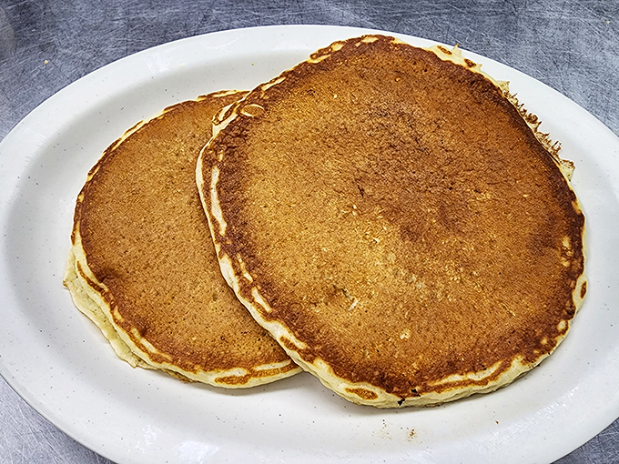 Pancakes the size of frisbees with that perfect golden hue. No artisanal maple-infused foam needed – just pure breakfast bliss.