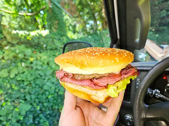 Road food nirvana! The pastrami burger enjoyed in the car proves some of life's greatest pleasures don't require a table, just a hungry spirit.
