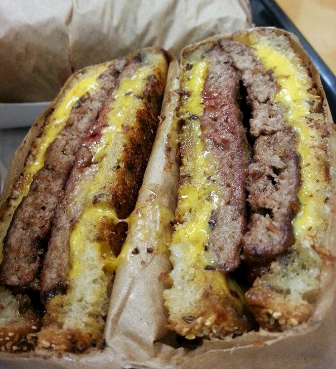 The patty melt in its natural habitat – where bread meets beef in a marriage blessed by cheese and sealed with a kiss of the grill.