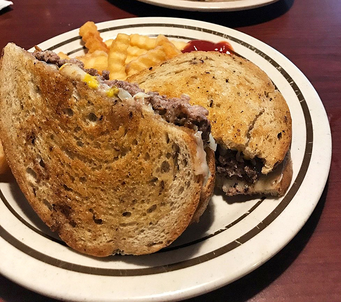 The legendary patty melt in all its glory—perfectly griddled rye bread embracing a juicy beef patty and melted cheese. Worth crossing county lines for.
