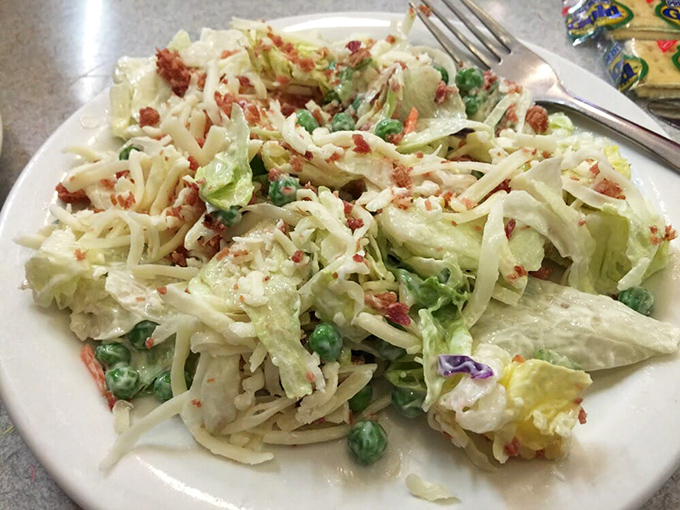 Pea salad that grandma would approve of—crisp, creamy, and studded with bacon bits like little flavor bombs waiting to detonate.