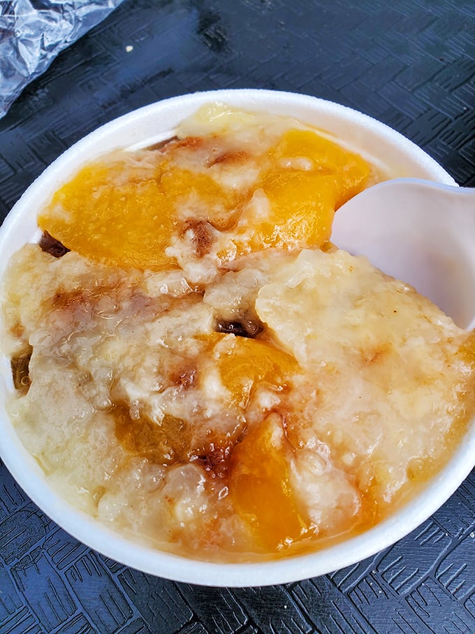 The peach cobbler arrives without fanfare, but one bite of those tender South Carolina peaches nestled under golden crust will change your life forever.