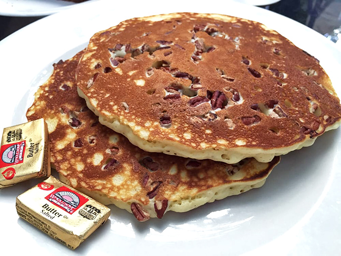 These pecan pancakes aren't just breakfast—they're an edible postcard from paradise, complete with butter pats melting like tiny tropical sunsets.