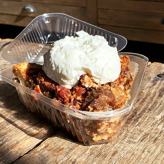 Dessert that demands attention—warm pecan pie topped with a cloud of whipped cream. Resistance is both futile and foolish.