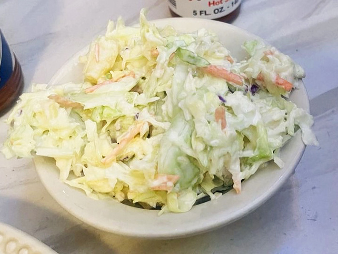 Coleslaw that knows its supporting role—crisp, fresh, and mercifully not drowning in mayo. The perfect cool counterpoint to hot chicken.