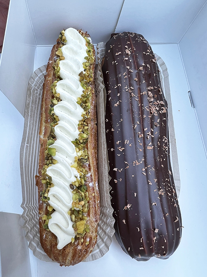The pistachio éclair looks like it should have its own Instagram account, while its chocolate companion waits patiently, knowing its turn for the spotlight is coming.