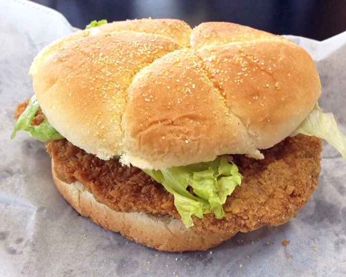 The pork tenderloin sandwich—Midwest engineering at its finest. Crispy, oversized, and requiring strategic first-bite planning to avoid structural collapse.
