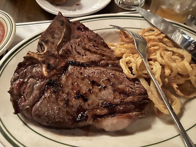 The porterhouse doesn't just command the plate—it rules it. This bone-in beauty offers a geography lesson in beef perfection.