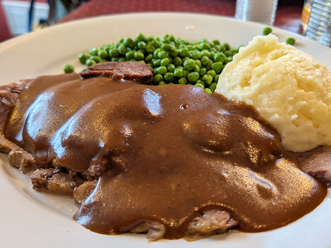 Pot roast that doesn't just fall apart—it surrenders completely, surrounded by mashed potatoes standing by to soak up that glorious gravy.