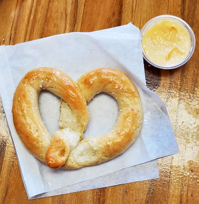 Golden pretzels paired with creamy cheese dip prove that simple pleasures often deliver the most satisfying experiences.