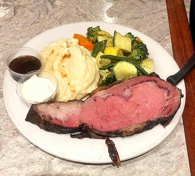 Prime rib cooked to that perfect rosy hue, accompanied by fluffy mashed potatoes and fresh vegetables—proof that diners can do dinner spectacularly.
