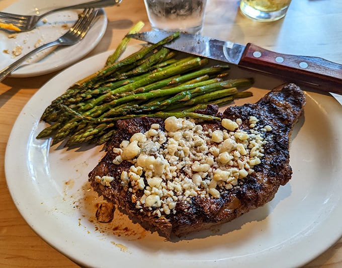 The Black and Blue Ribeye with asparagus isn't just dinner – it's what food dreams are made of when cheese meets beef.