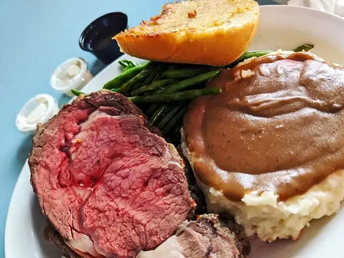 Prime rib so perfectly pink it could make a vegetarian weep, alongside mashed potatoes that clearly never came from a box. Sunday dinner perfection.