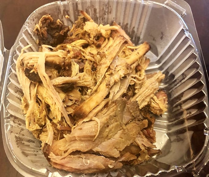 Pulled pork so tender it looks like it's been combed rather than pulled, with those crispy bark bits that barbecue aficionados fight over like hidden treasure.