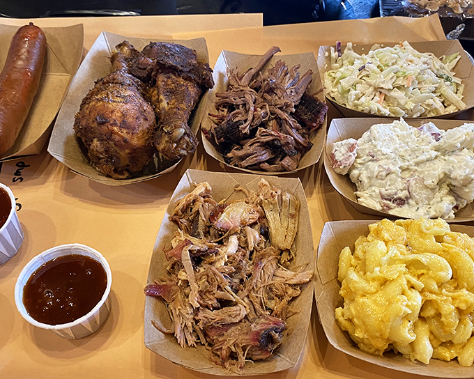 A BBQ spread that would make a vegetarian question their life choices—chicken, pulled pork, and sides that refuse to be upstaged.