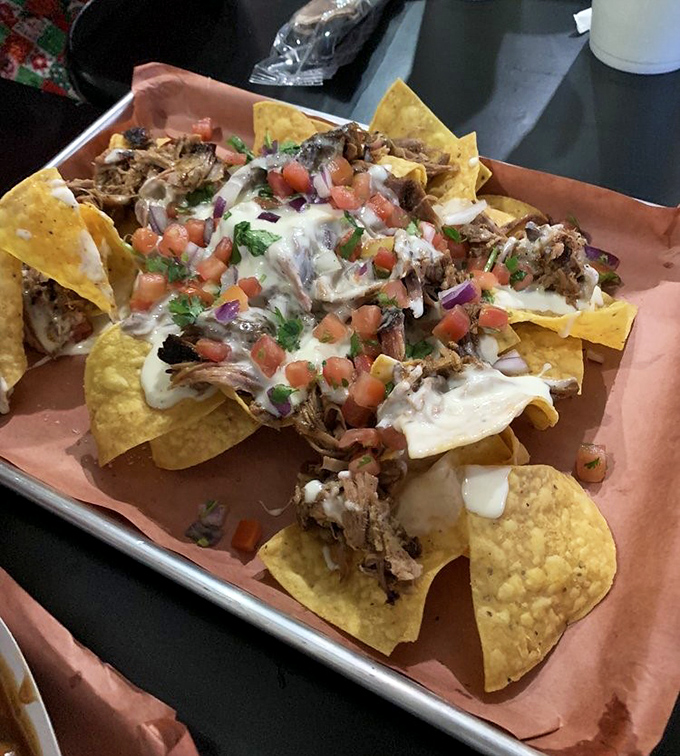 Barbecue nachos: where Tex-Mex meets Missouri smoke. Crispy chips loaded with tender pulled meat, queso, and fresh pico create the ultimate shareable indulgence—if you're willing to share.