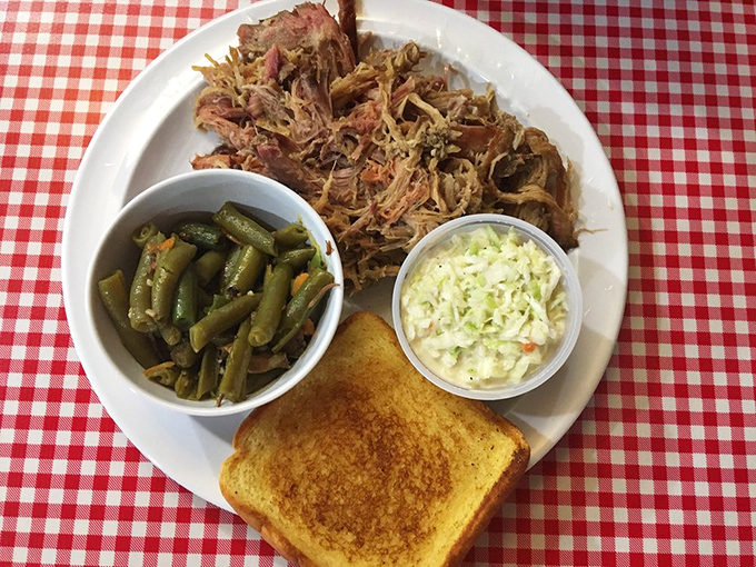Pulled pork that doesn't just fall apart – it practically introduces itself to the green beans and coleslaw before melting into that perfectly toasted bread.