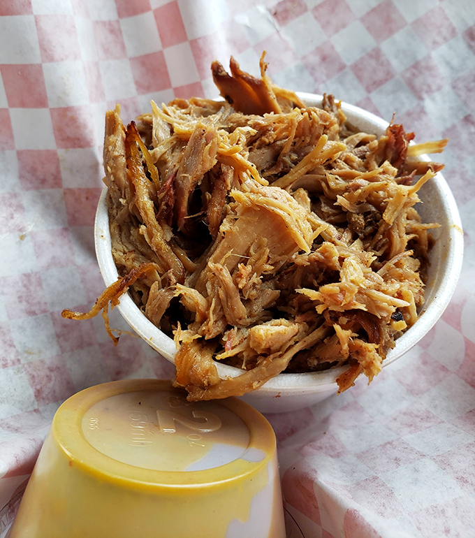 Pulled pork perfection in a cup—tender strands of smoky goodness that would make even Carolina barbecue devotees nod in respectful approval.