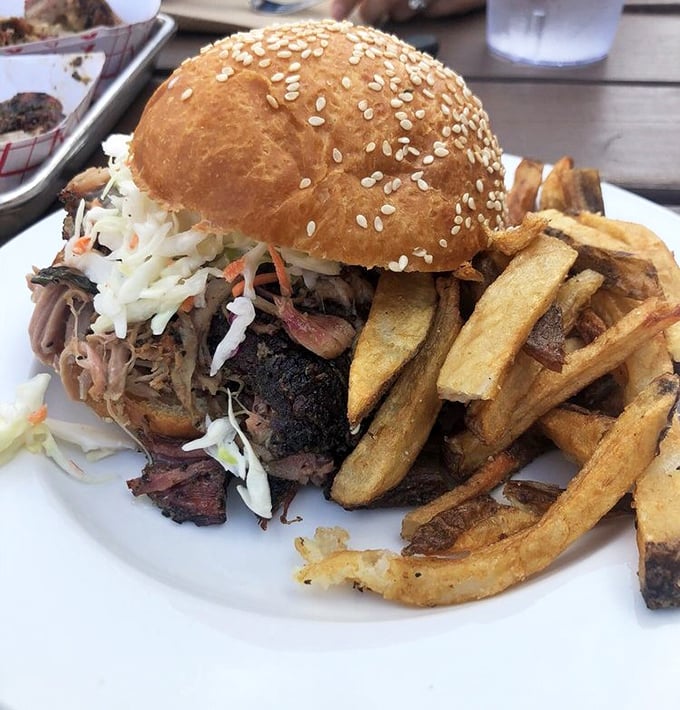 This isn't just a sandwich—it's an architectural marvel of pulled pork, slaw, and golden fries that makes skyscrapers jealous.