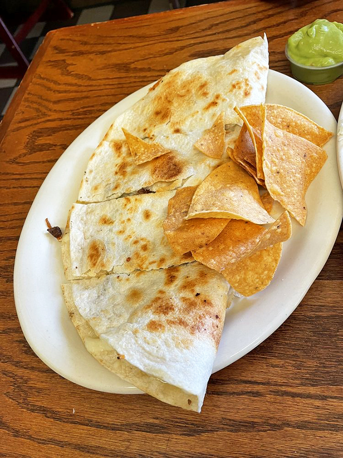 A quesadilla that achieves the golden ratio of crispy exterior to molten cheese interior, with a side of guacamole that deserves its own fan club.