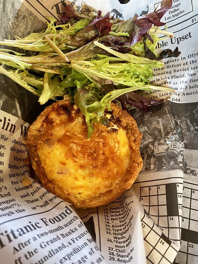 Newspaper and quiche—a combination as timeless as Carson and McMahon. This savory masterpiece has layers of flavor that would make even a French chef nod approvingly.