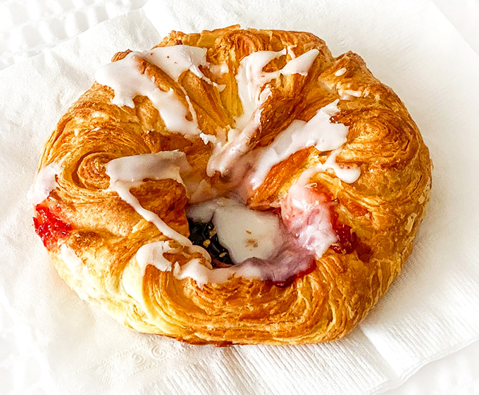 The raspberry Danish – where flaky pastry meets sweet-tart filling in a relationship more perfect than any Hollywood romance.