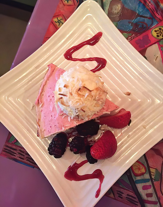This isn't just dessert—it's Florida sunshine transformed into a slice of pink paradise topped with a cloud of coconut whipped cream.