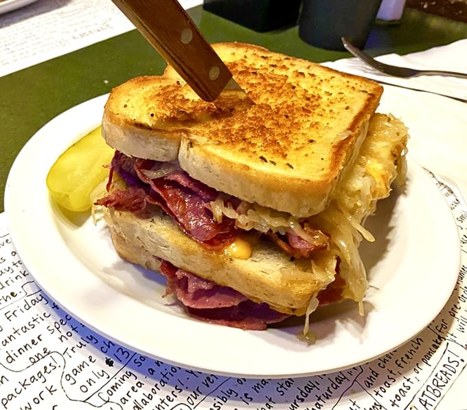 A sandwich so stuffed with personality it needs a knife to hold it together. This Reuben isn't just a meal – it's an engineering marvel.