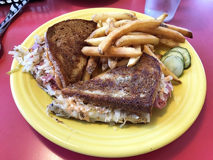 The legendary Reuben in all its glory – perfectly grilled rye bread barely containing the mountain of corned beef and sauerkraut within.