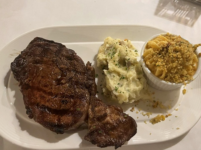 A ribeye that deserves its own ZIP code, paired with garlic mashed potatoes and mac & cheese. Comfort food elevated to an art form.