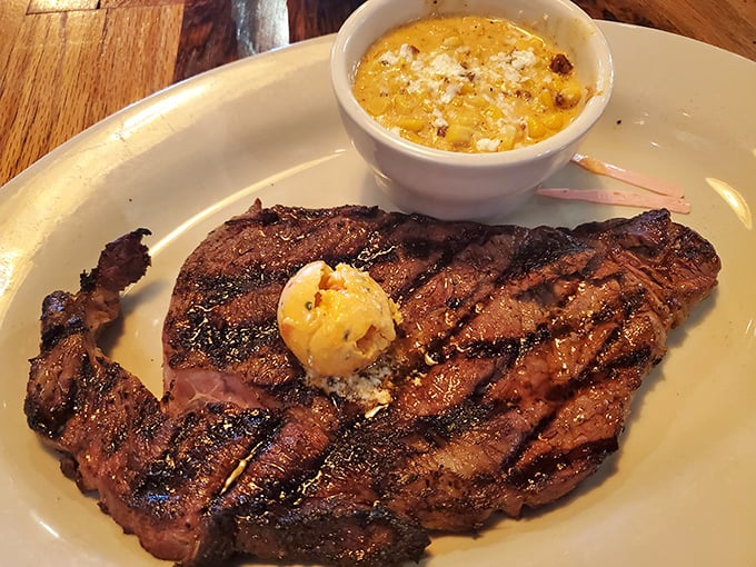 This ribeye with its pat of butter slowly melting into beefy perfection is what food dreams are made of. The corn pudding isn't just a side—it's a co-star.