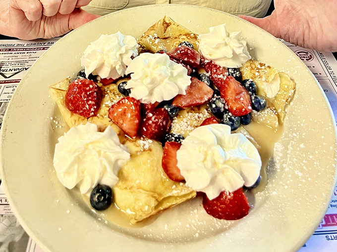 Berry-topped pancakes that belong in a dessert museum. Those whipped cream dollops and fresh berries turn breakfast into an occasion worth getting up for.