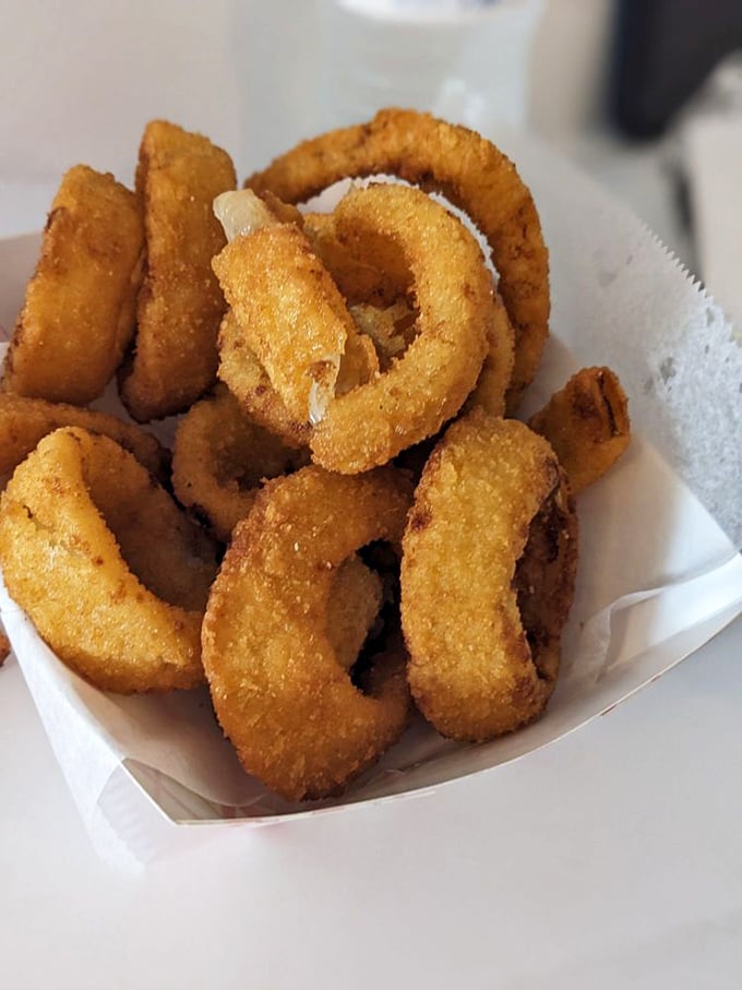 These golden onion rings aren't just side dishes – they're crispy halos of happiness that deserve their own moment of silence.