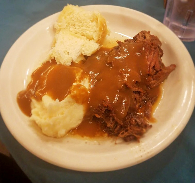 Tender roast beef swimming in rich gravy alongside cloud-like mashed potatoes—proof that heaven might actually be a place on earth.