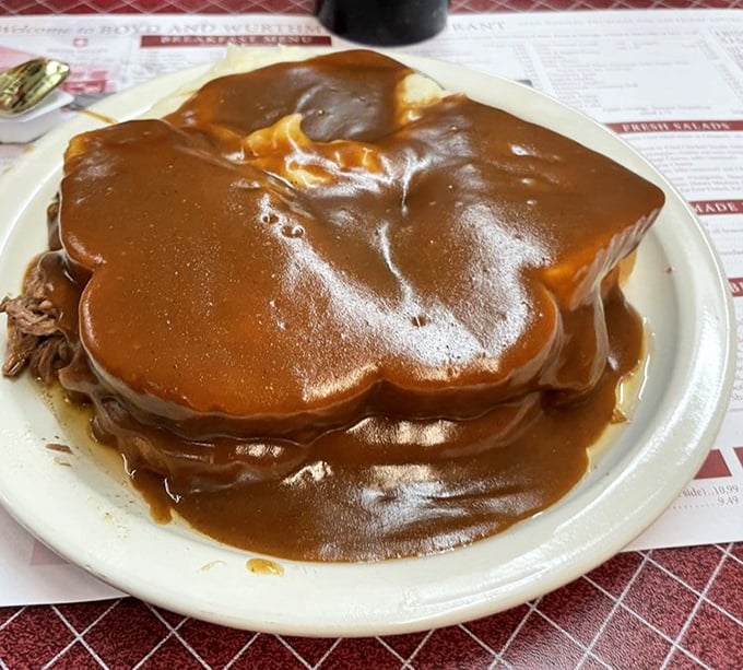 Gravy shouldn't be an accessory; it should be the main event. This roast beef sandwich drowns in rich brown gravy that would make French chefs weep.