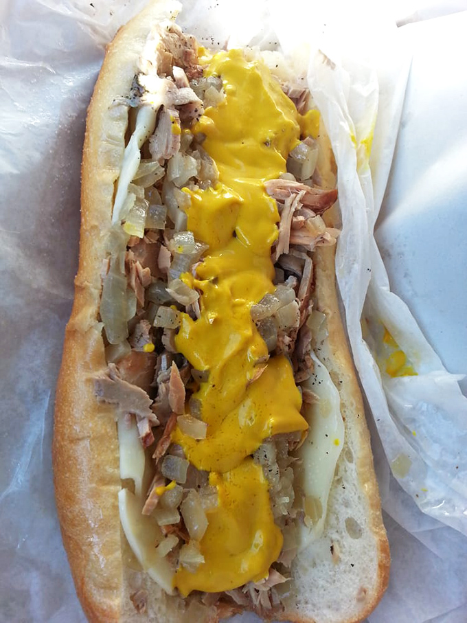 Cheese Whiz cascading like a golden waterfall over thinly sliced steak and onions. This isn't just a sandwich—it's Philadelphia's soul on bread.