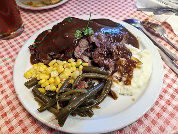 Tender roast beef swimming in rich gravy alongside fresh vegetables – comfort food that earns straight A's every time.