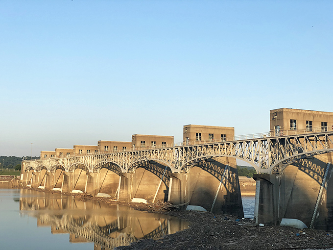The Robert C. Byrd Lock and Dam stretches across the Ohio River like a concrete centipede, controlling the water that shaped this town's destiny.