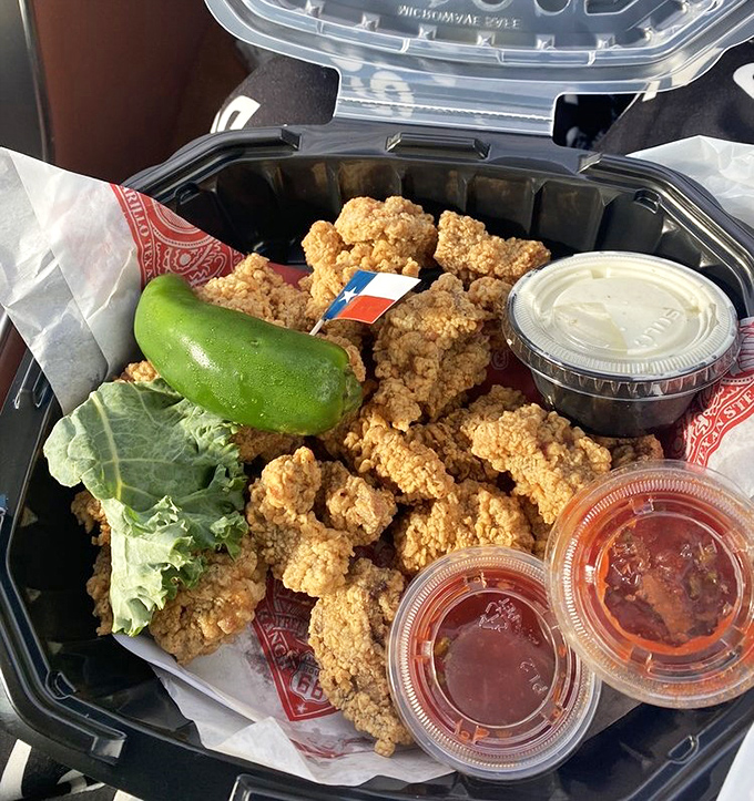 Golden-fried chicken strips that would make the Colonel jealous. That tiny Texas flag isn't compensating—it's just reminding you where good food comes from. 