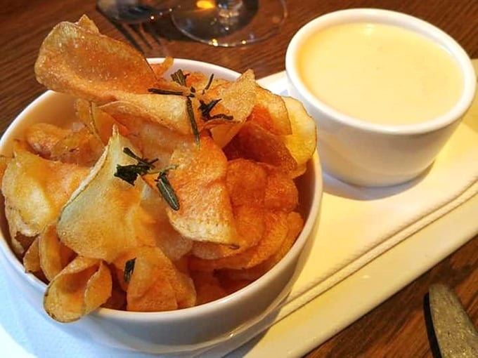 These aren't your average potato chips. Rosemary-infused kettle crisps with a side of something heavenly for dipping—proof that simple pleasures are often the best.
