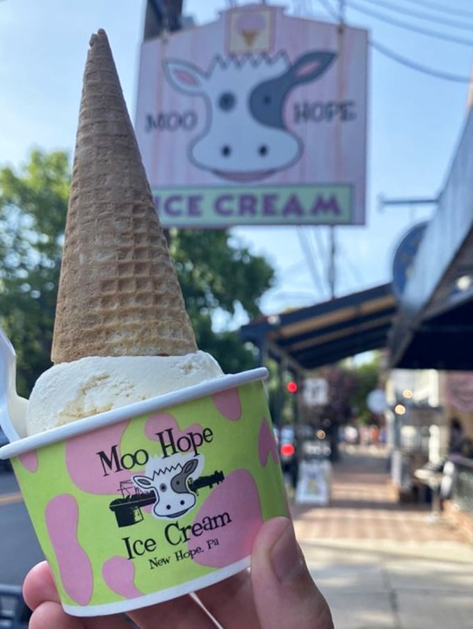 Vanilla ice cream in a classic cone with the iconic Moo Hope sign in the background—sometimes simplicity is the ultimate sophistication.