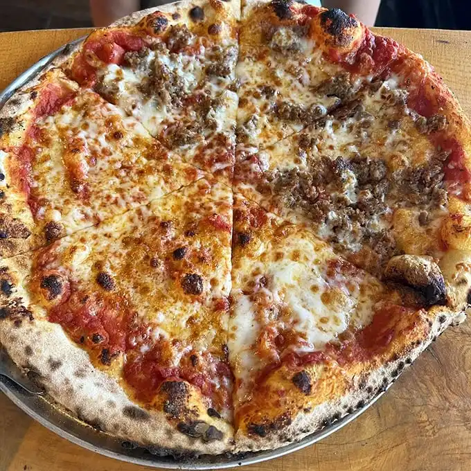 A perfectly blistered crust cradles that ideal ratio of sauce, cheese, and sausage—proof that a well-made sausage pizza, executed flawlessly, is revolutionary.