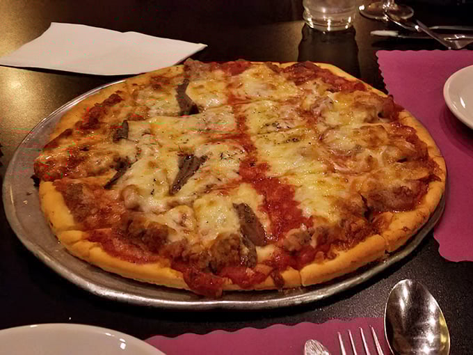 Pizza perfection doesn't need fancy toppings—just a perfectly balanced sauce, melty cheese, and sausage that would make any nonna nod in approval.