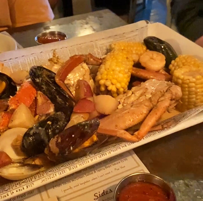The Low Country Boil arrives like edible buried treasure – a glorious heap of seafood, sausage, and corn that demands you get your hands dirty.