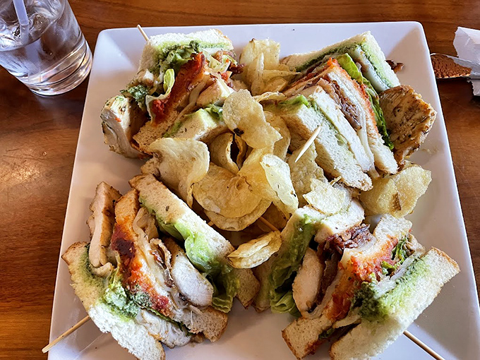 This seafood club sandwich towers with fresh ingredients like a delicious architectural marvel of flavor.