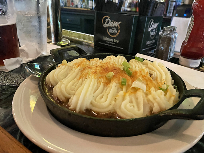 Shepherd's pie arrives in its own cast iron skillet, the mashed potato peaks browned to perfection—comfort food that speaks with an Irish brogue.
