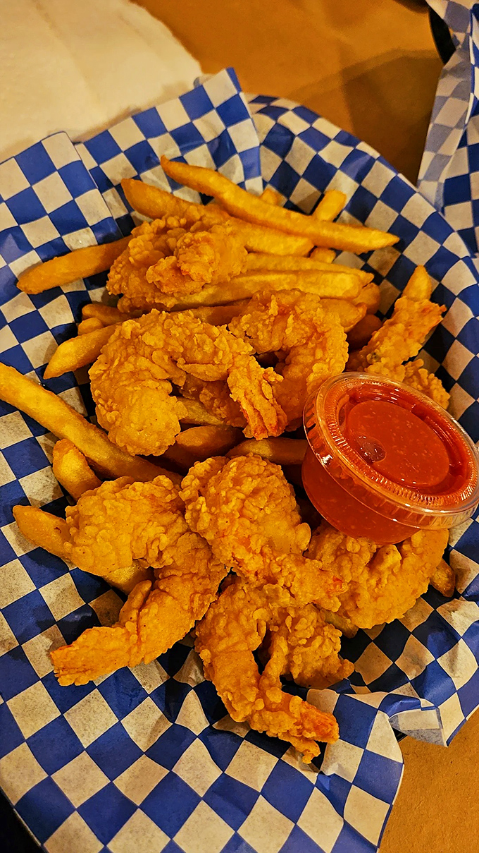 Golden-fried shrimp nestled among crispy fries – proof that sometimes the simplest pleasures are the most satisfying.