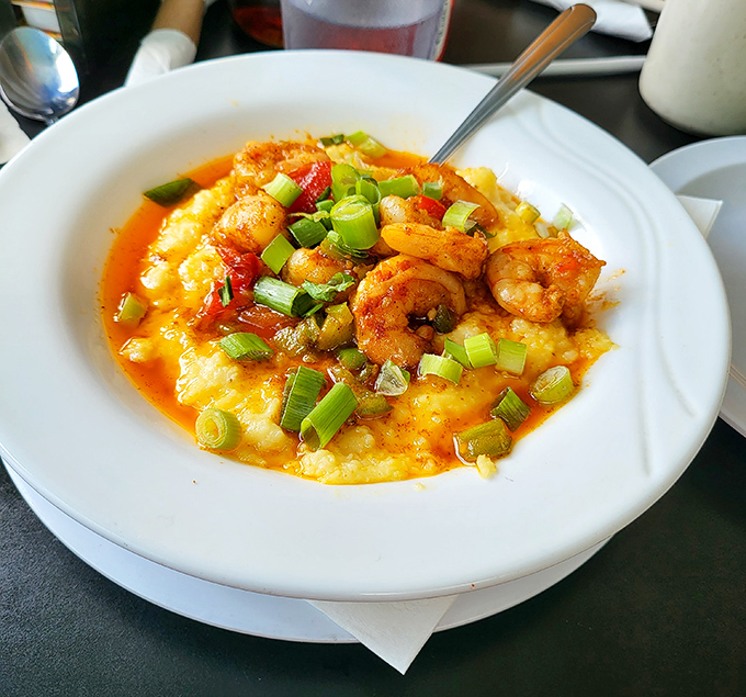 Shrimp and grits elevated to art form – those plump crustaceans lounging on creamy cornmeal like they're at a five-star resort.