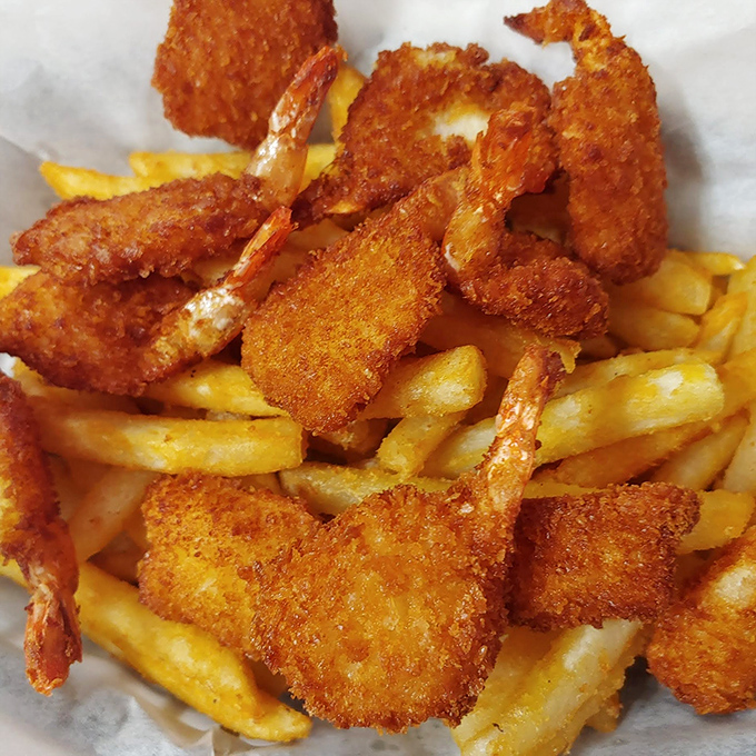 Golden-fried shrimp perched atop a bed of crispy fries—a seafood and potato marriage that would make Neptune himself request seconds.